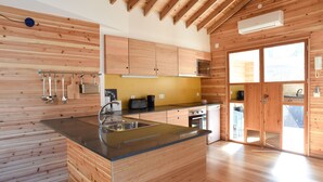 Uma cozinha moderna com armários de madeira, uma ilha central e uma janela grande.