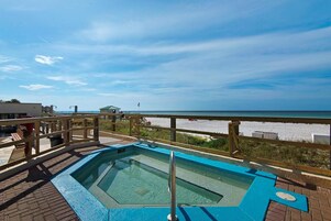 Piscina no terraço com vista clara para a praia e o oceano.