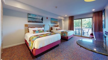 Quarto de hotel com duas camas, uma janela ampla com vista, uma varanda e uma mesa redonda.