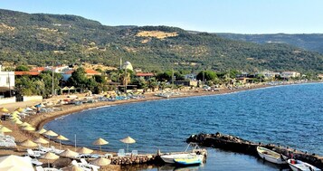 Perto da praia, barracas de praia de cortesia, guarda-sóis 