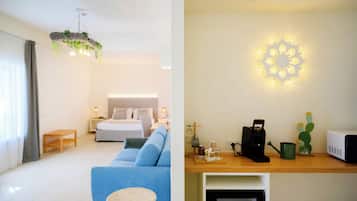 Quarto de hotel moderno com cama, sofá azul e área de refeições com cafeteira e decoração com cactos.