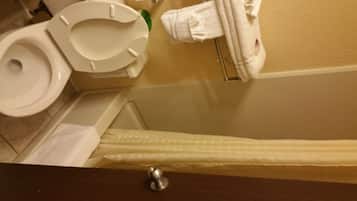Um banheiro com vaso sanitário, porta-toalhas com toalha e cortina de chuveiro.