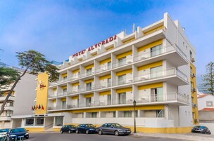 Um hotel com vários andares, varandas e fachada amarela.