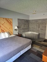 Quarto, 1 cama King, banheira de hidromassagem | Cofres nos quartos, ferros/tábuas de passar roupa, Wi-Fi de cortesia