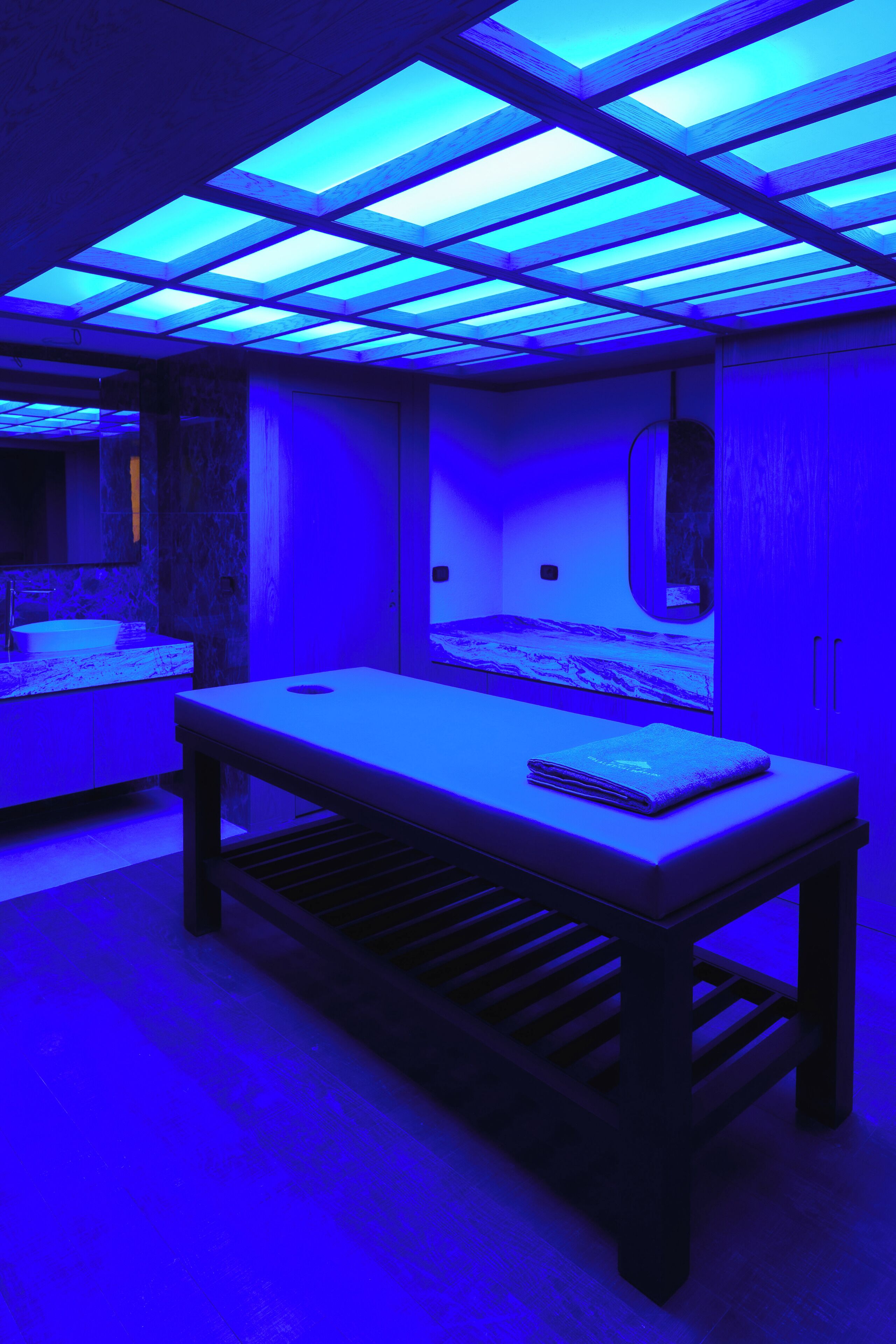 Um quarto com uma cama, uma mesa e uma pia.