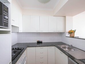 Um frigorífico, um micro-ondas, um forno, uma placa de cozinha 