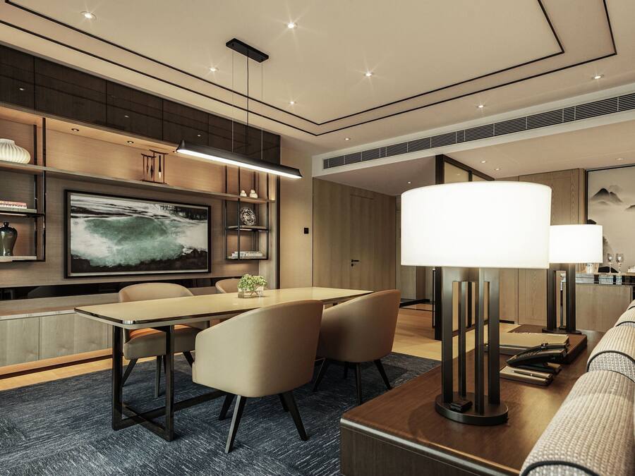 Quarto de hotel moderno com área de refeições, uma televisão de tela grande e um sofá.