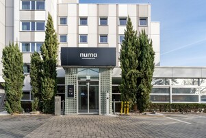 Um edifício moderno com entrada de vidro, com a inscrição 