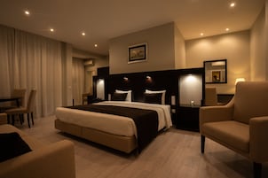 Quarto, 1 cama King | Frigobar, cofres nos quartos, cortinas blackout, quartos à prova de som