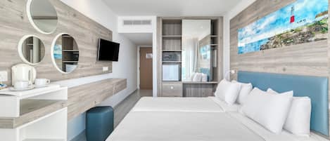 Quarto de hotel moderno com uma cama grande, televisão, quadro e detalhe na parede em madeira.