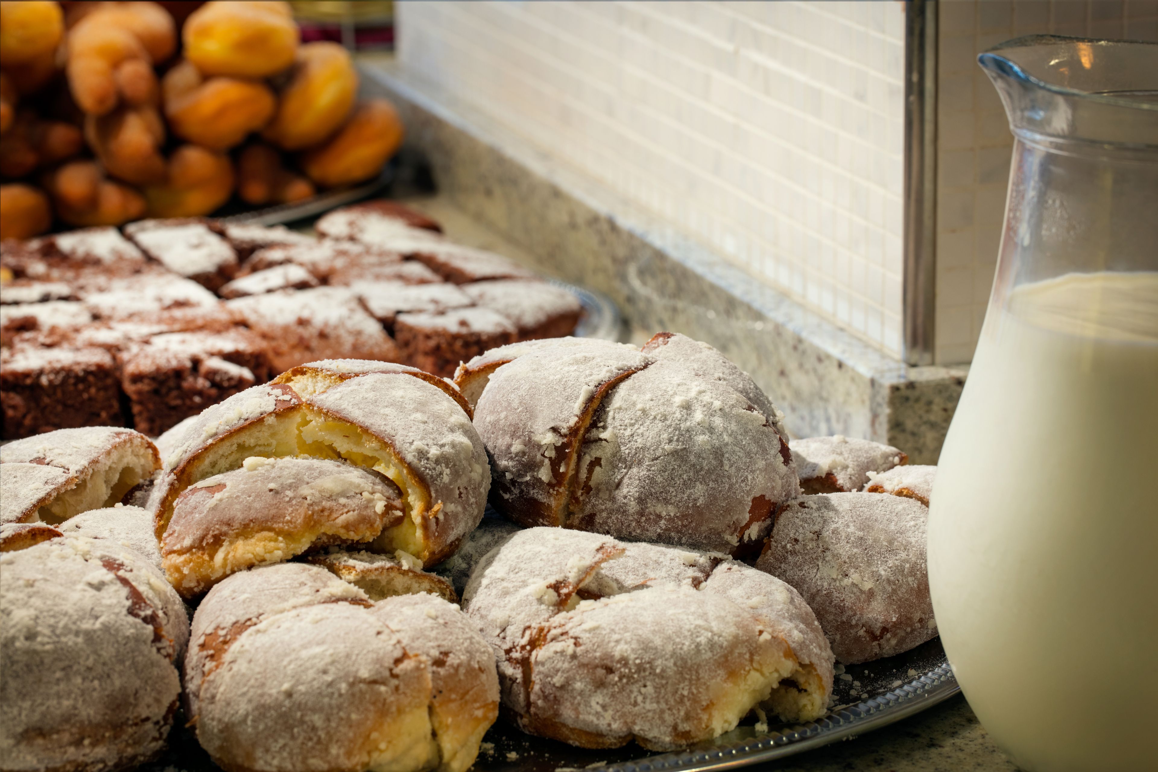 Diversos doces, incluindo formatos redondos e retangulares, em uma bandeja.
