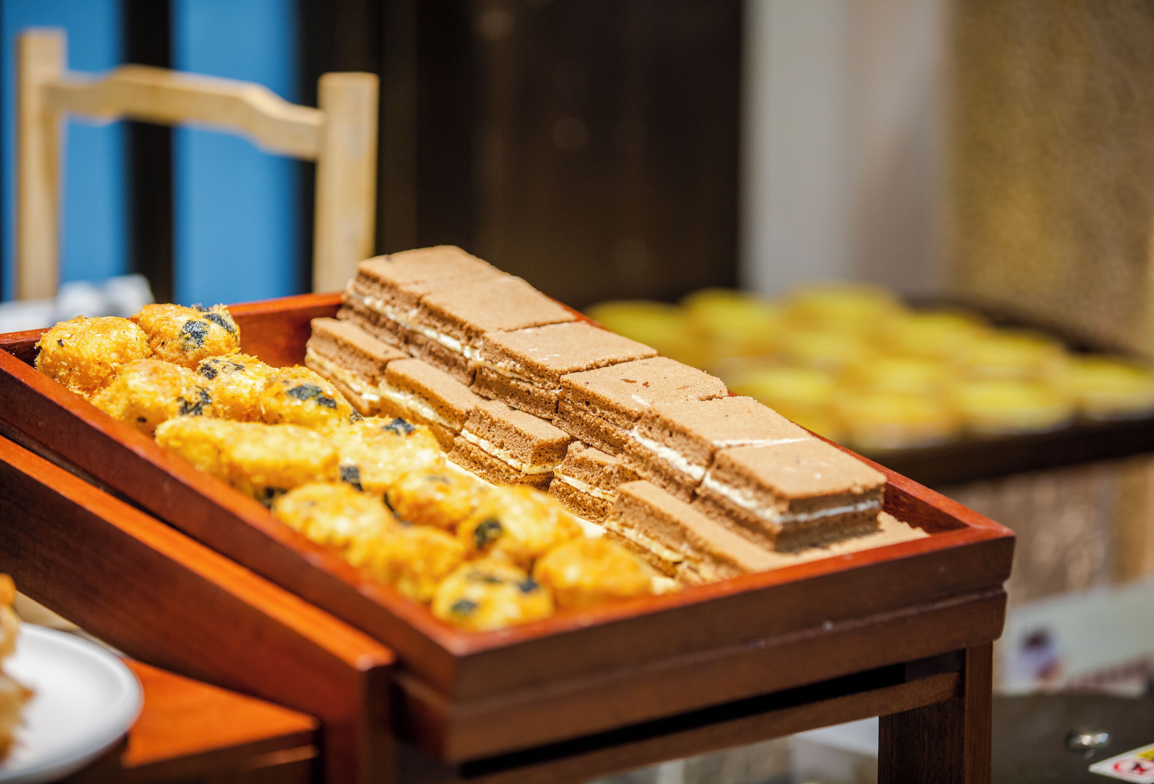 Uma mesa de buffet com diversos doces, incluindo bolos e pâtisseries.