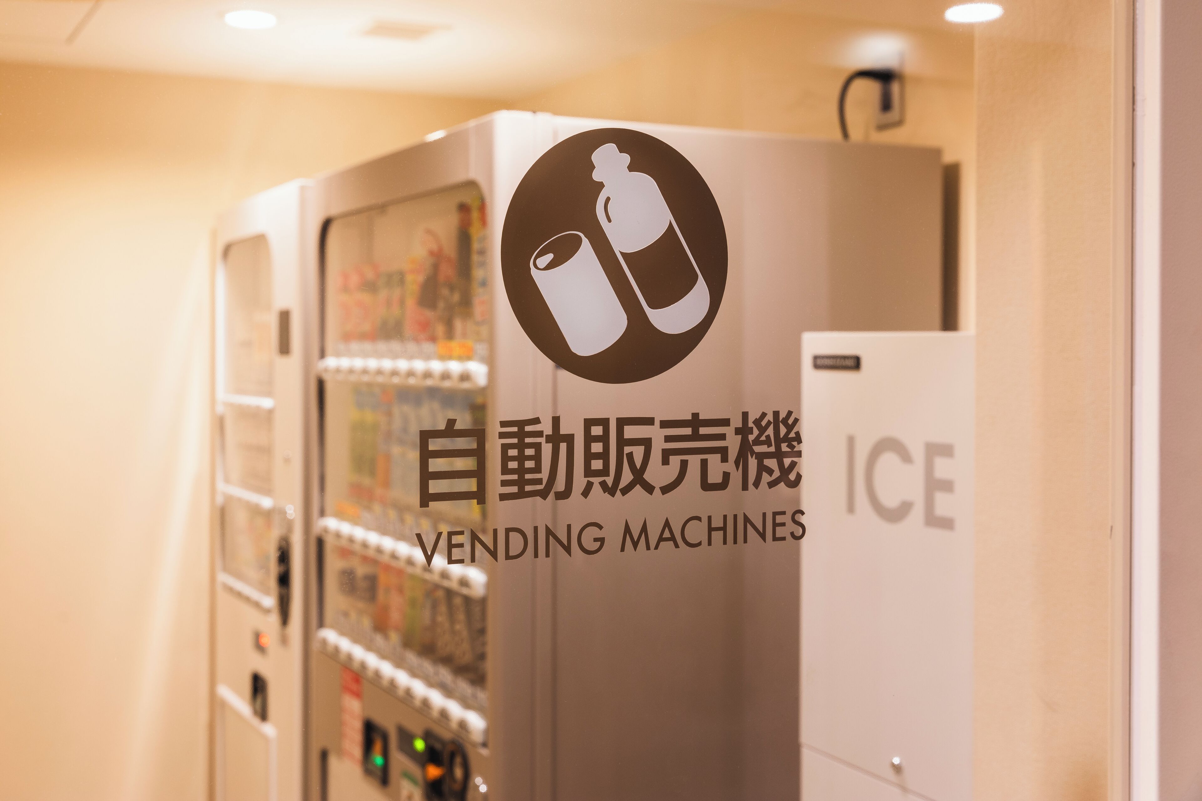 Máquina automática de bebidas com ícone de bebida e os textos 'VENDING MACHINES' e 'GELO'.