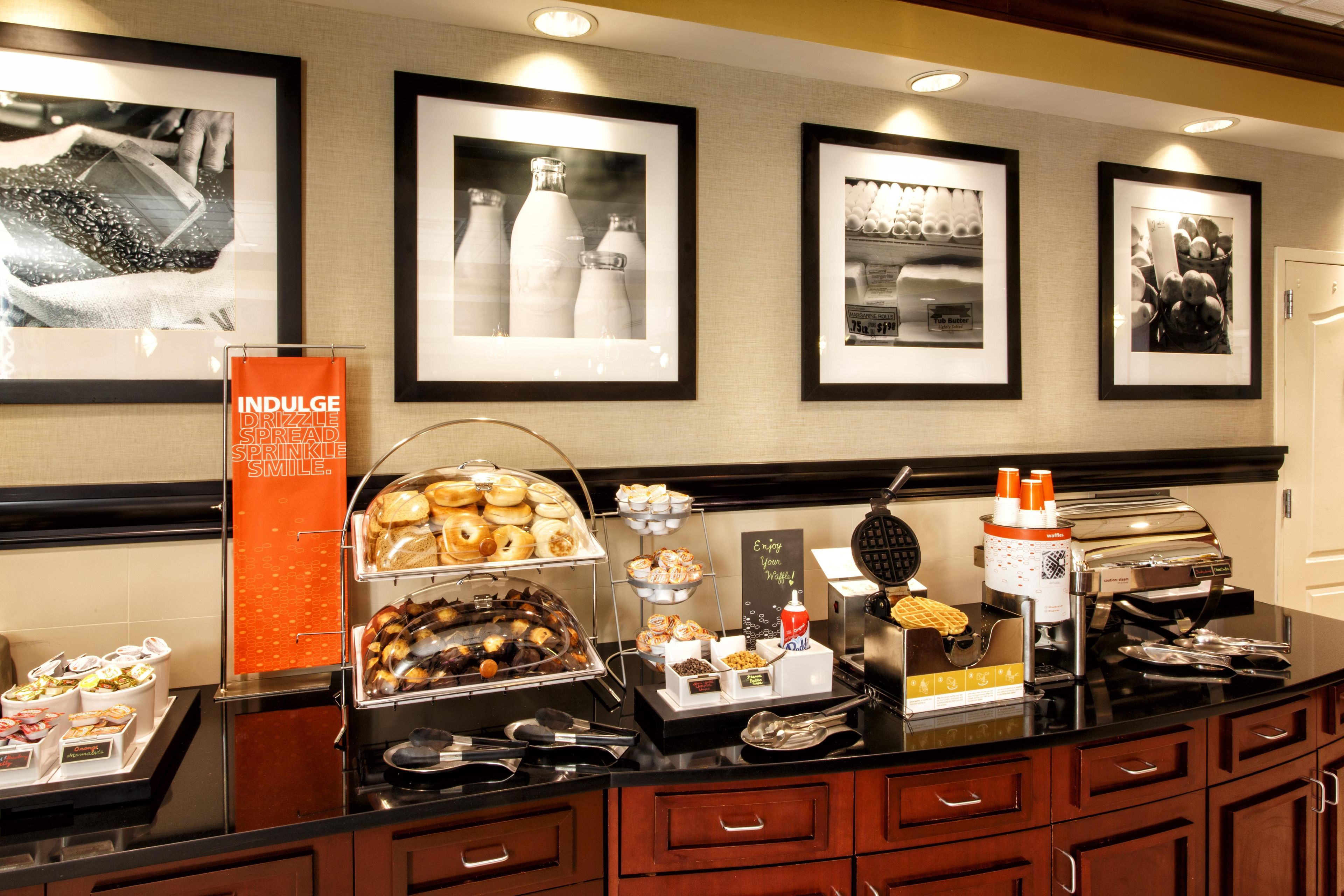 Buffet de café da manhã com diversas opções de comida e um espaço para café.