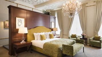 Quarto de hotel espaçoso com cama grande, lustre e vista da cidade.