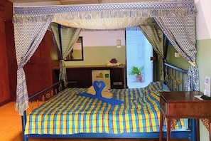Um quarto com uma cama, uma escrivaninha e uma cadeira.