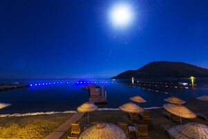 Uma praia privada, espreguiçadeiras, guarda-sóis de praia 