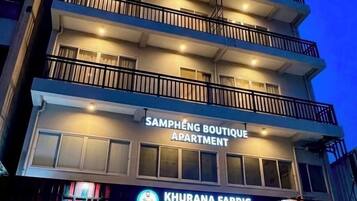 Um edifício com vários andares, com um apartamento boutique e uma loja de tecidos.
