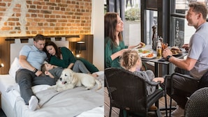 Um quarto aconchegante com parede de tijolos, uma cama com um cachorro e uma área de jantar com mesa e cadeiras.