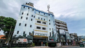 Um edifício de vários andares com uma placa grande que diz 'Green Palace'.