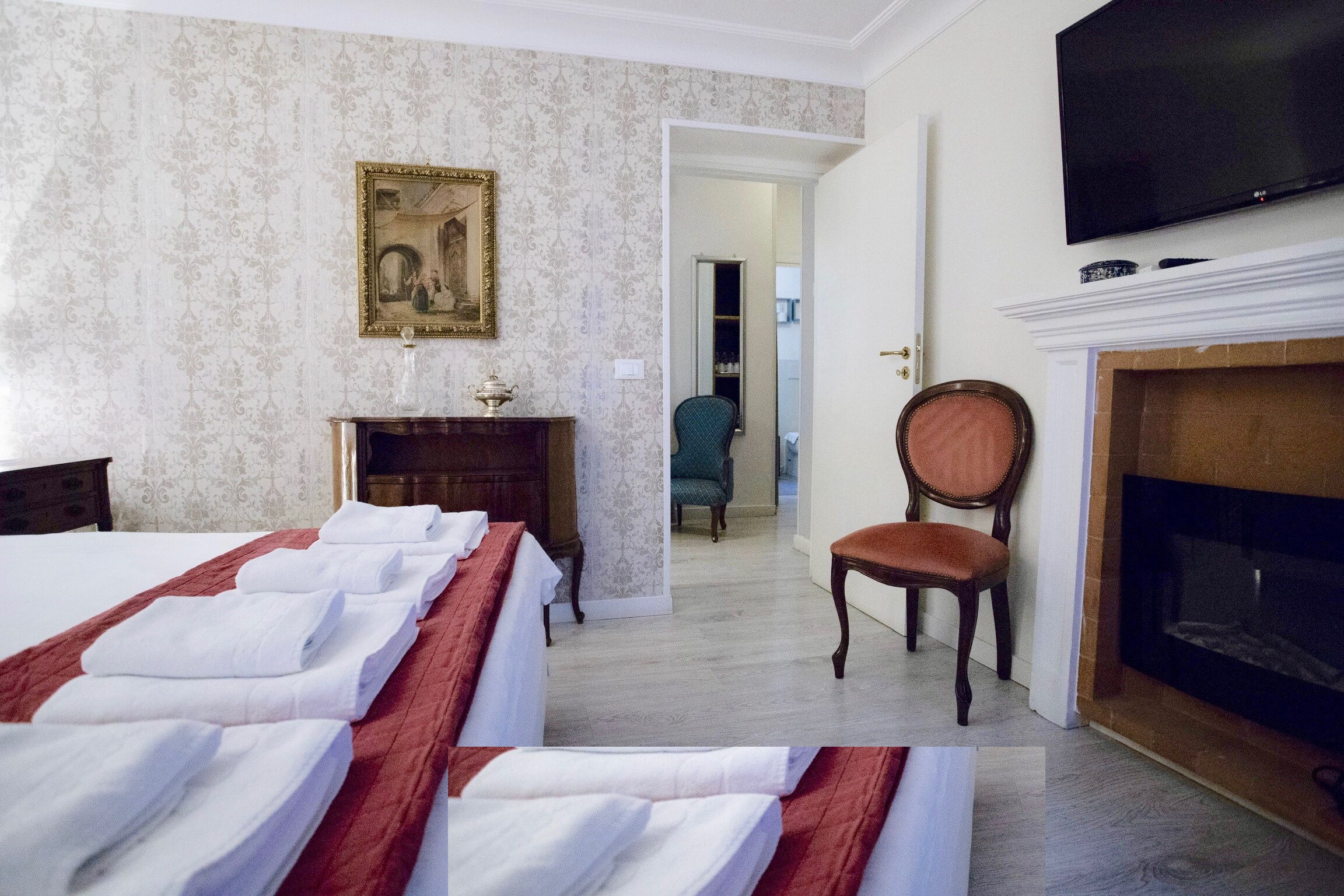 Quarto de hotel com cama, lareira, televisão e um quadro na parede.