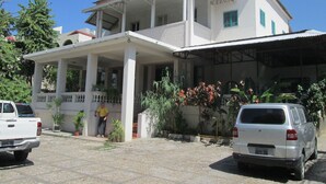 Uma casa de dois andares com varanda coberta e garagem.