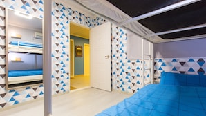 Quarto com beliche, porta dando acesso a outro espaço e paredes com padrão.