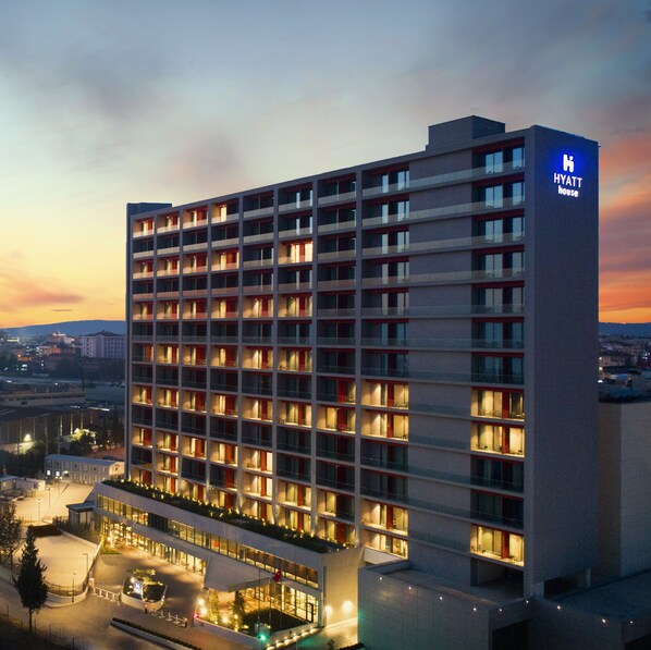 Um hotel com vários andares e design moderno, com uma placa bem visível do Hyatt House.