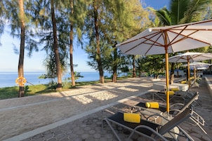 Na praia, guarda-sóis, toalhas de praia, bar na praia