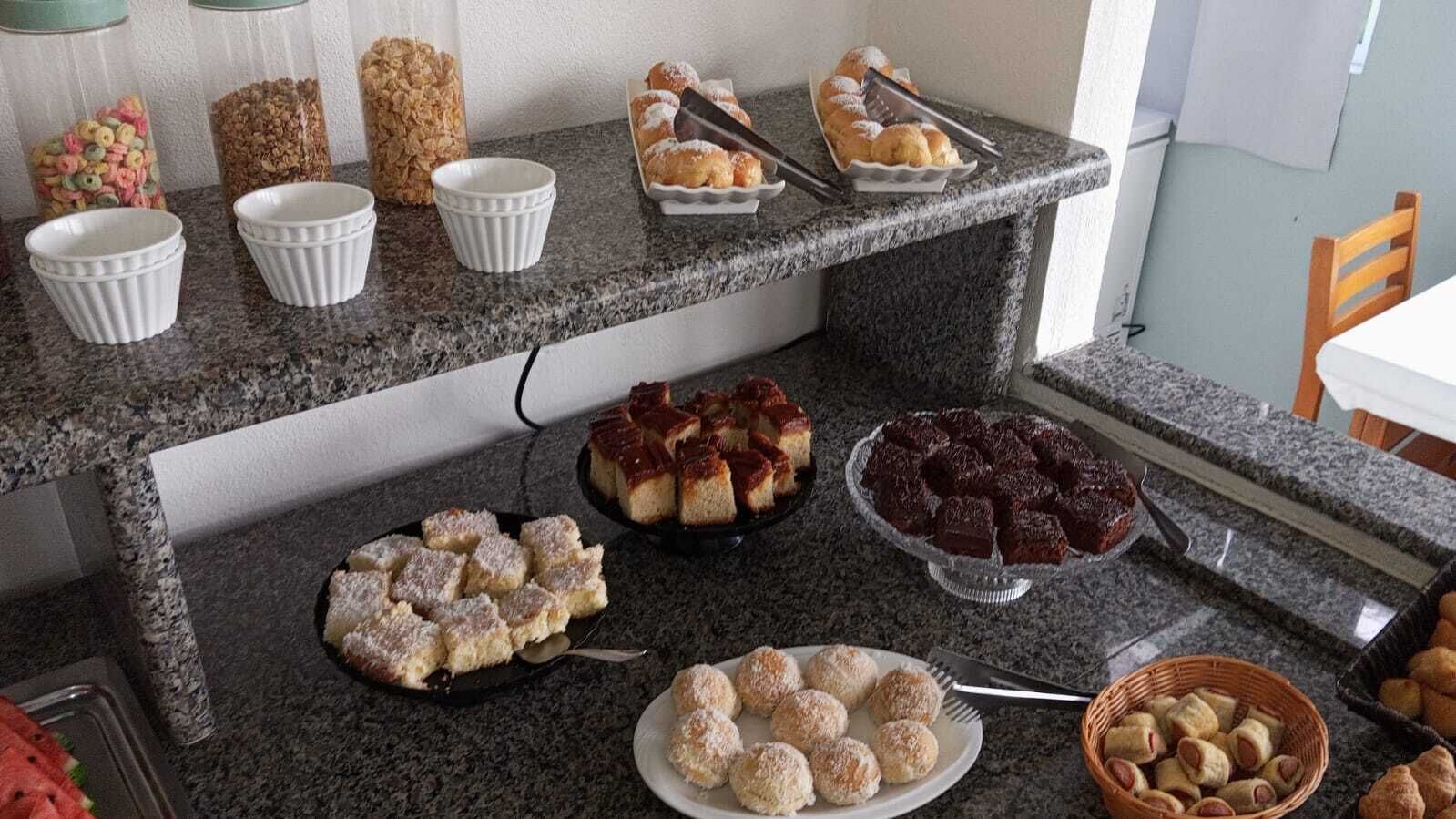 Uma bancada de cozinha com diversos produtos de panificação e recipientes.