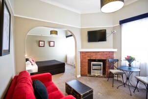 Quarto, 1 cama Queen | Área de estar | TV de tela plana