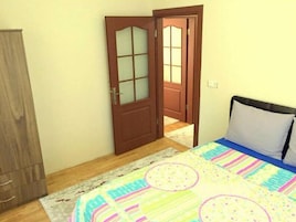 Quarto com cama, guarda-roupa e porta que dá para outro espaço.