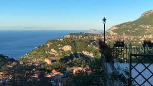 Uma vila costeira com vista para o mar e montanhas.
