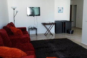 Apartamento Comfort, 1 quarto | Sala | TV de ecrã plano 