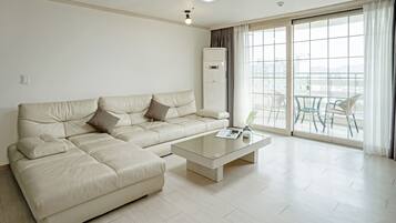 Apartamento Premier | Sala de estar | Televisor de ecrã plano de 75 polegadas com canais por cabo, televisor