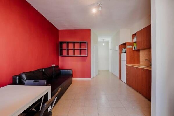 Apartamento, 1 quarto | Sala de estar | TV de ecrã plano