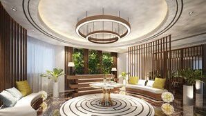Um lobby moderno com área central circular, disposição de assentos e teto com iluminação embutida.