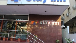 Placa de Stay Inn com design moderno, combinando cores azul e laranja.