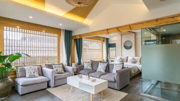 Suite Premier, vista para o jardim | Sala | Televisor