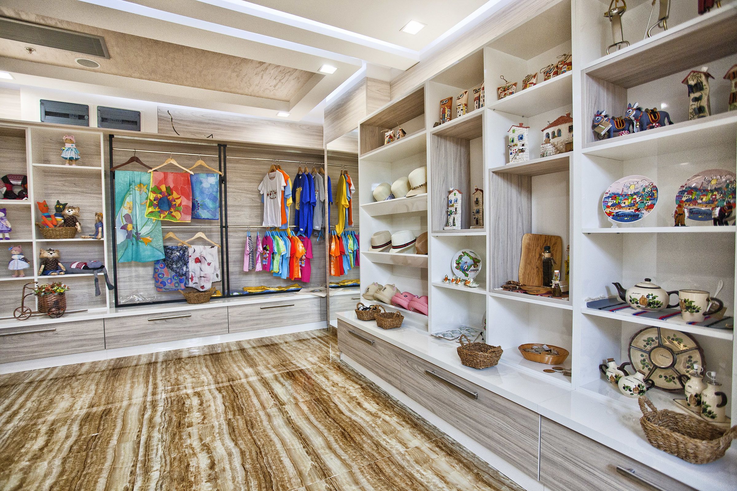 Quarto bem organizado com guarda-roupa, estantes com objetos decorativos e um tapete estampado.