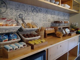 Disposição de buffet com diversos alimentos e acompanhamentos.