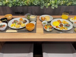 Um buffet de café da manhã com diversos pratos e bebidas.