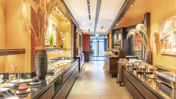 Uma área de buffet com diversos alimentos e um balcão extenso.