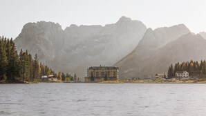 Um edifício à beira do lago, com vista para as montanhas.
