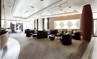 Um hall amplo com design moderno, destacando um balcão de recepção curvo, diversas áreas de estar com sofás e pufes, e uma luminária grande fixada na parede.