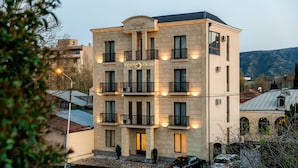 Um hotel com vários andares, varandas, uma placa com a inscrição 'PRESORT ORCHID' e vista da área circundante.