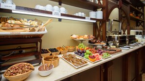 Um buffet com diversos alimentos e utensílios.