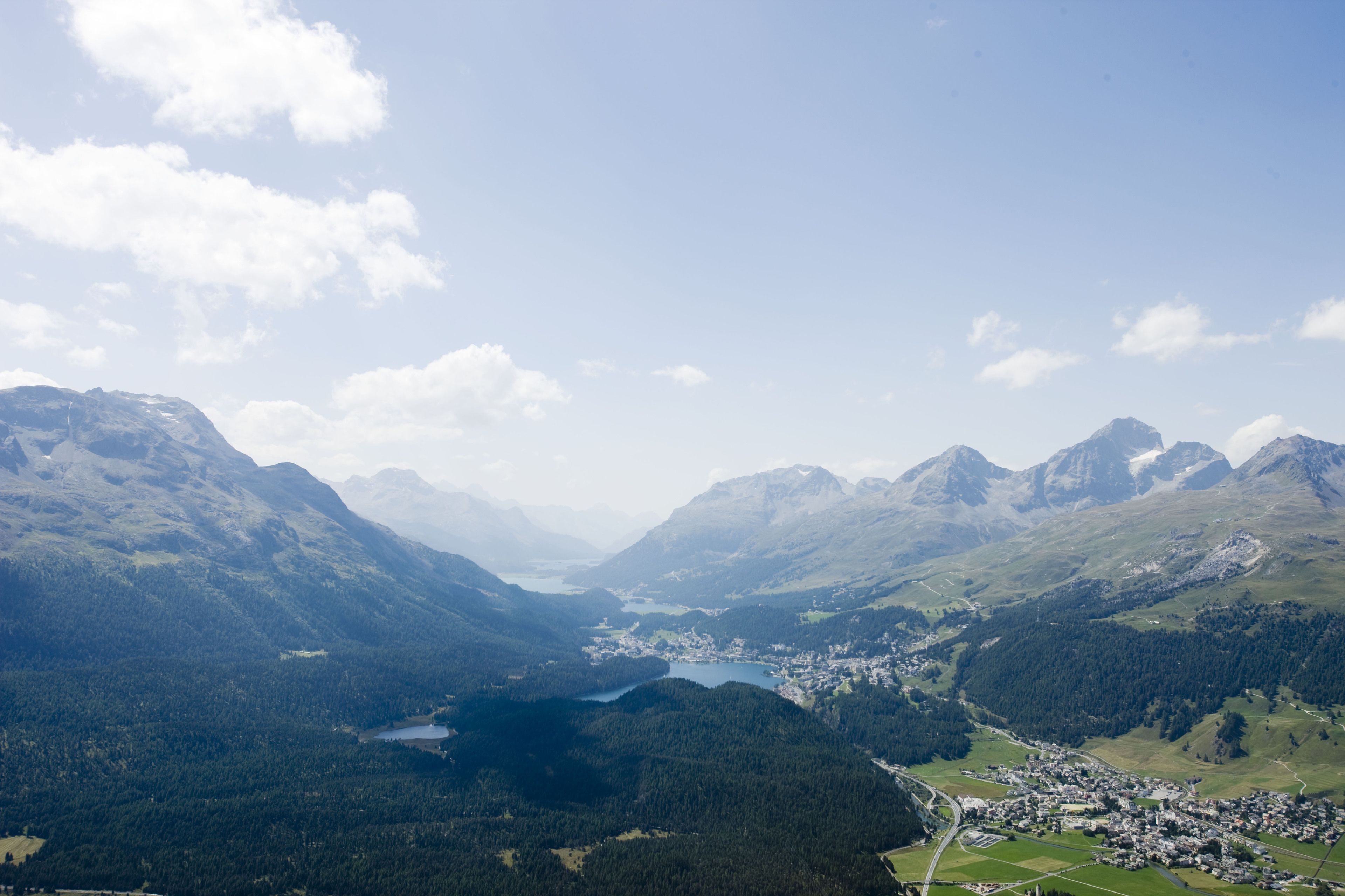 Paisagem montanhosa com uma cidade aninhada num vale.