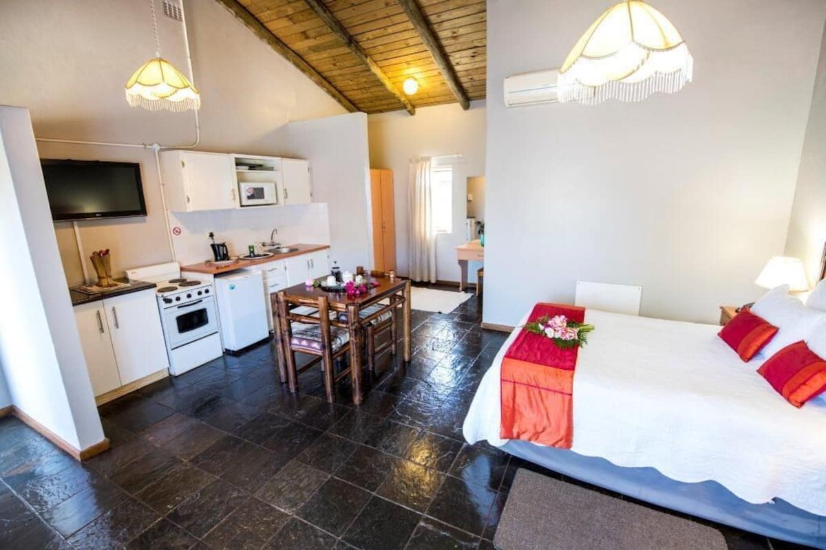 Quarto casal | Área de estar | TV de tela plana