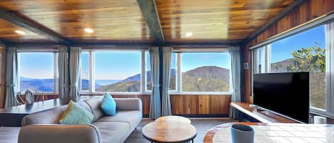 Suíte panorâmica, 1 quarto | Área de estar